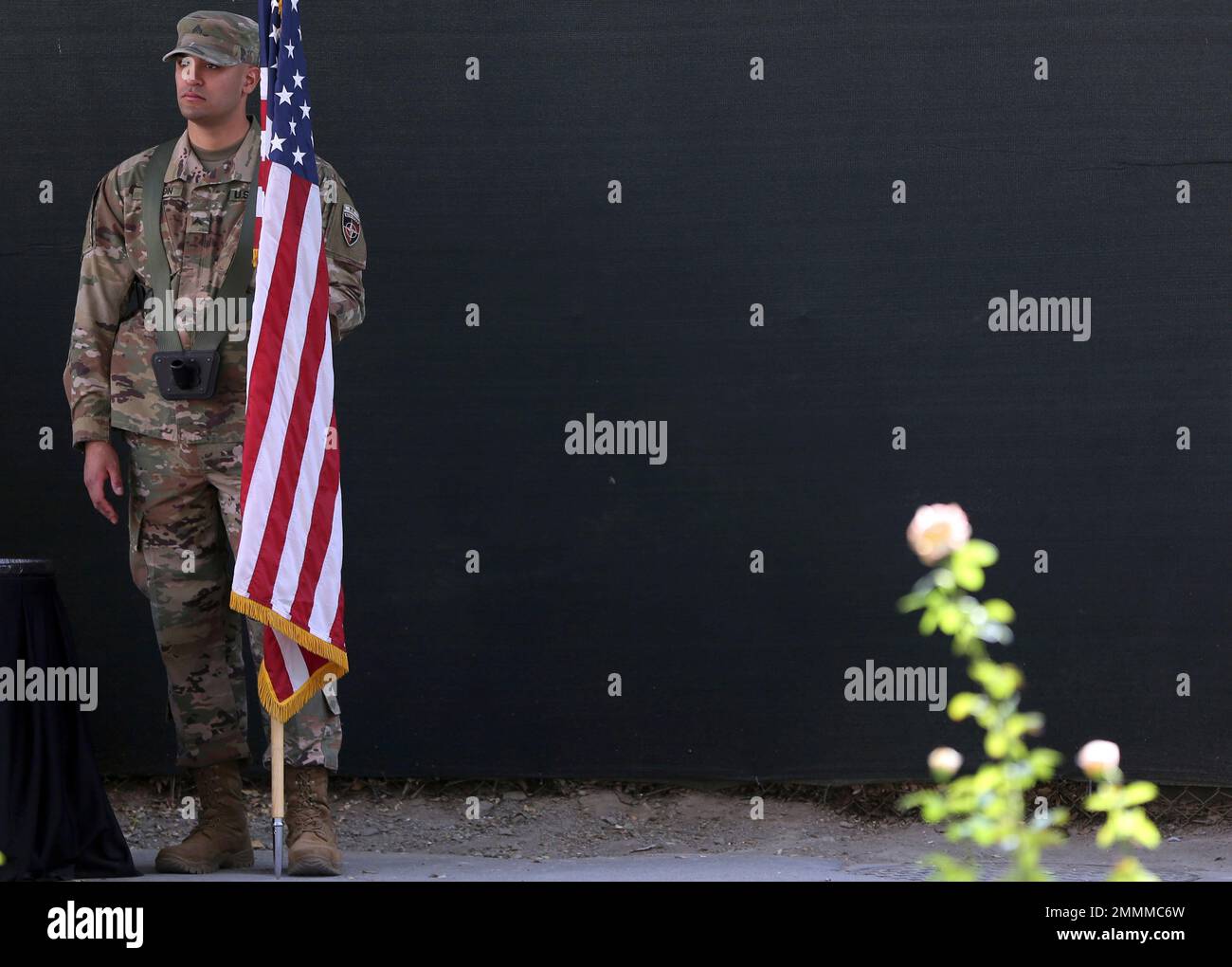 A U.S. Army soldier holds a flag during the change of command ceremony ...