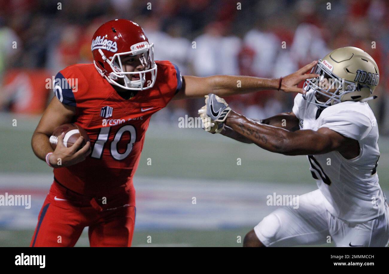 Fresno State quarterback Jorge Reyna stiff-arms Idaho's Dorian Clark ...