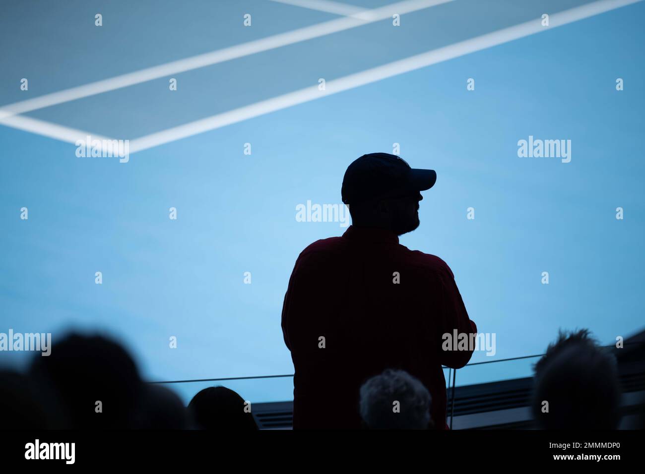 tennis fan watching a tennis match at the australian open eating food ...