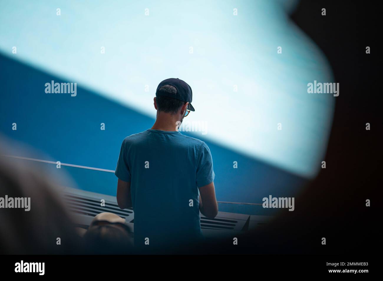 tennis fan watching a tennis match at the australian open eating food ...