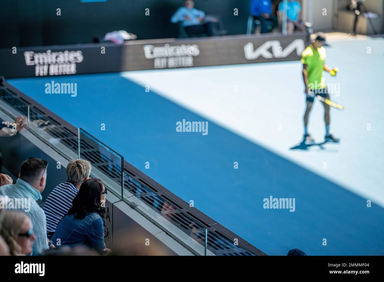 tennis fan watching a tennis match at the australian open eating food ...