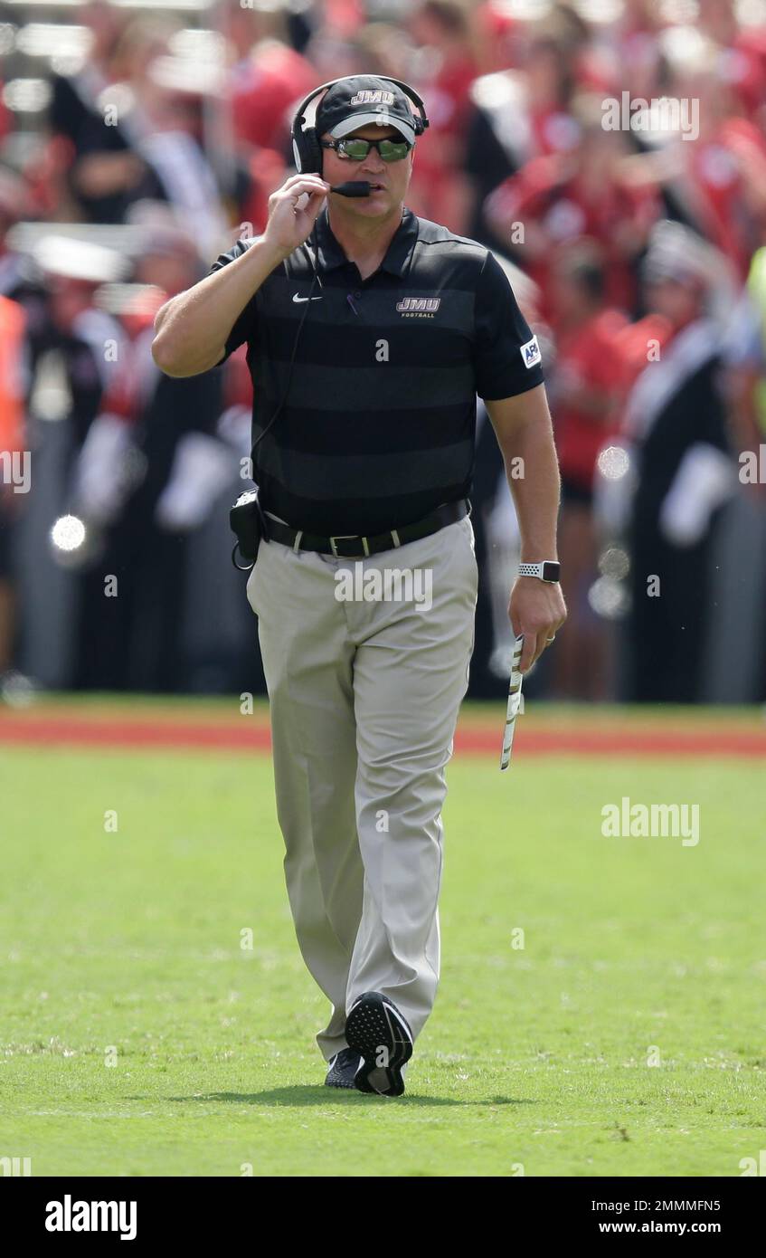 James Madison head coach Mike Houston talks on his radio during the ...