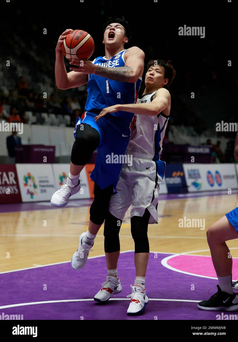 Taiwan's Chou Yihsiang, left, reacts as he is fouled by South Korea's ...