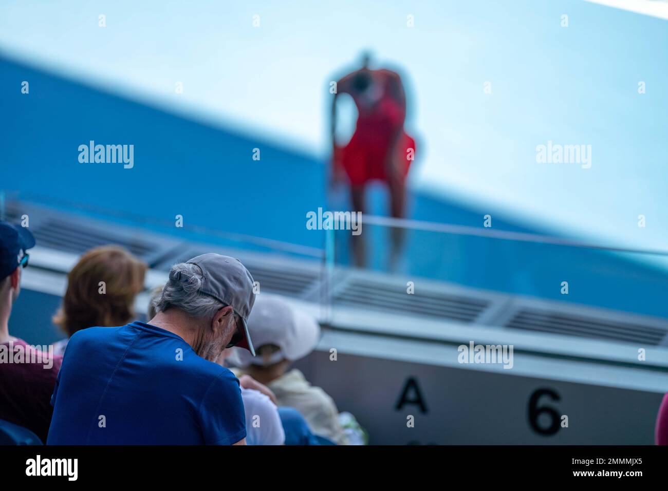 tennis fan watching a tennis match at the australian open eating food ...