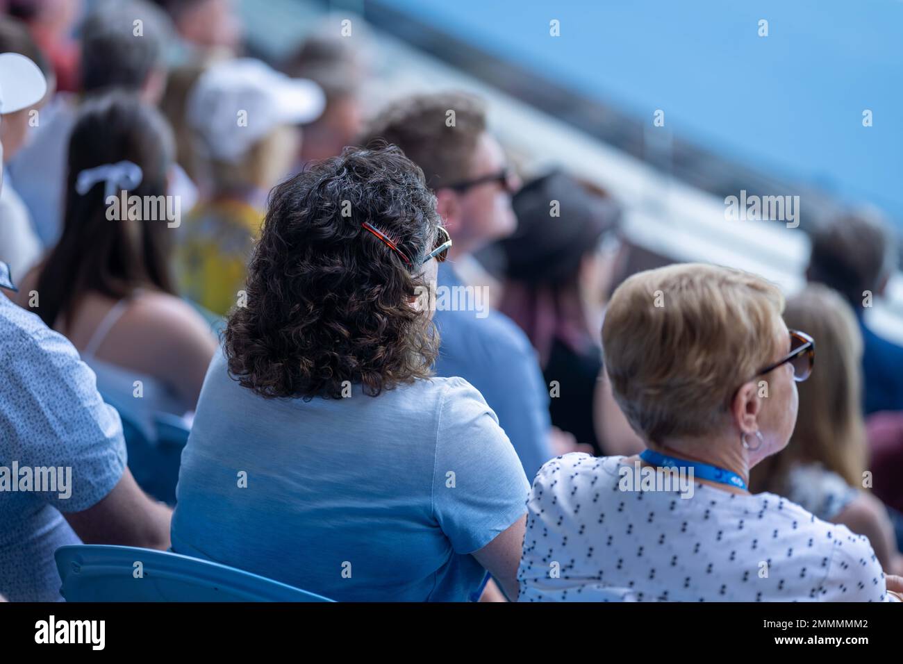 tennis fan watching a tennis match at the australian open eating food ...