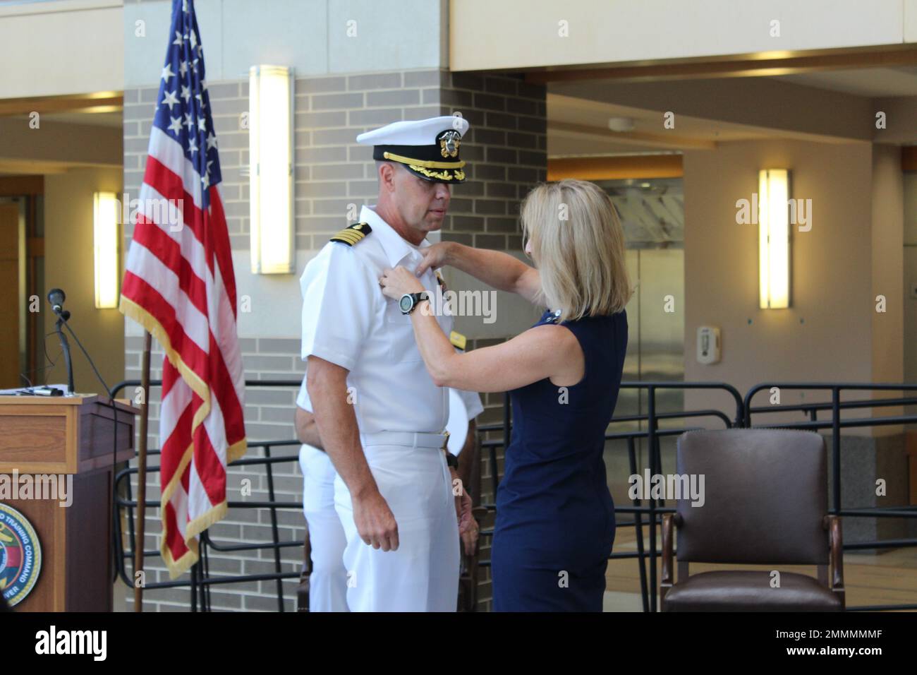 Leah Hawker, the wife of Capt. Jeremy J. Hawker, pins on his command ...