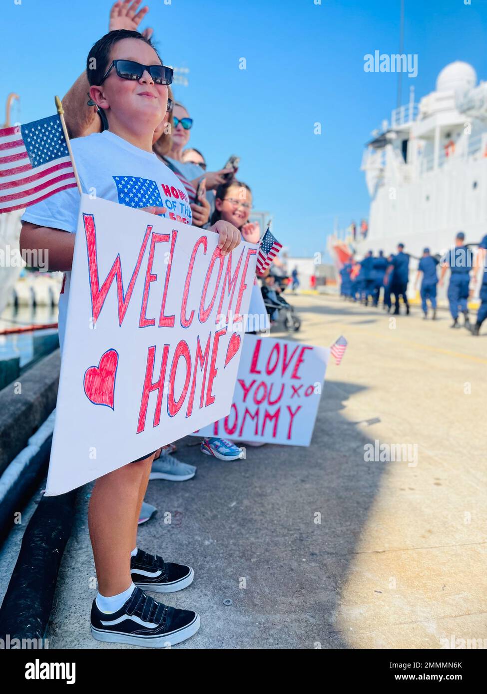 Family members of the USCGC Legare (WMEC 912) crew display welcome-home ...