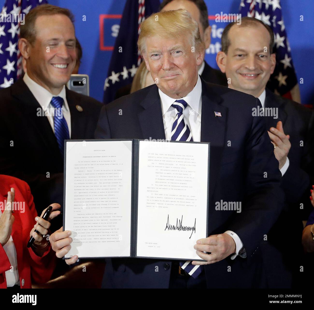 President Donald Trump, center, shows off an executive order he signed ...