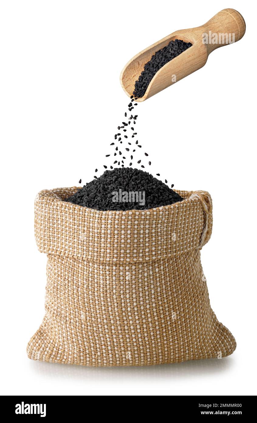 black cumin seeds falling from scoop in bag isolated on white ...