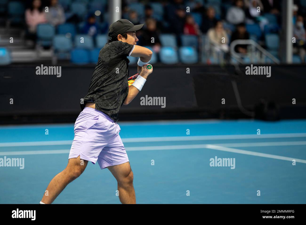 Tennis player serving in a tennis match, with leg drive in a game of ...