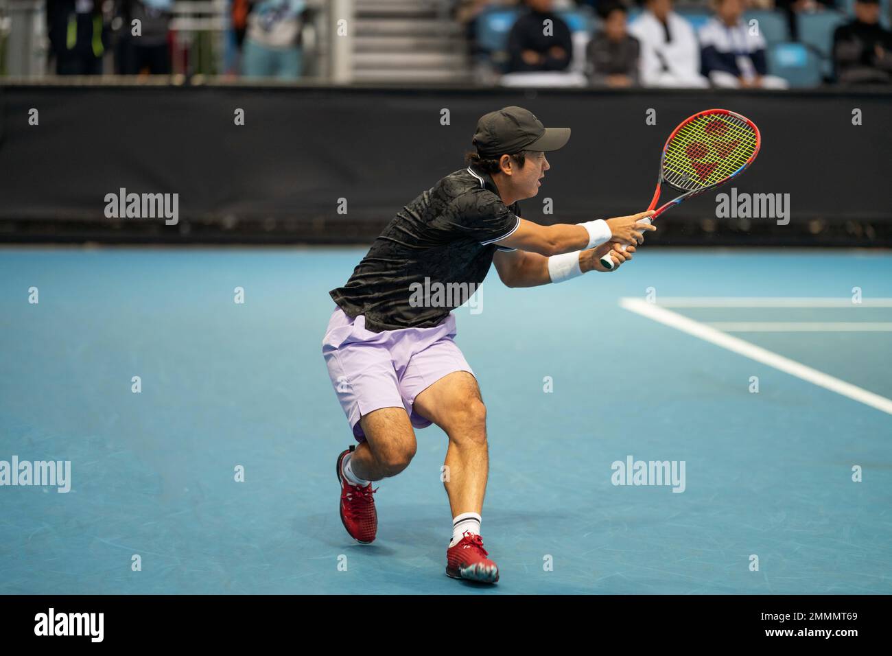 Tennis player serving in a tennis match, with leg drive in a game of ...