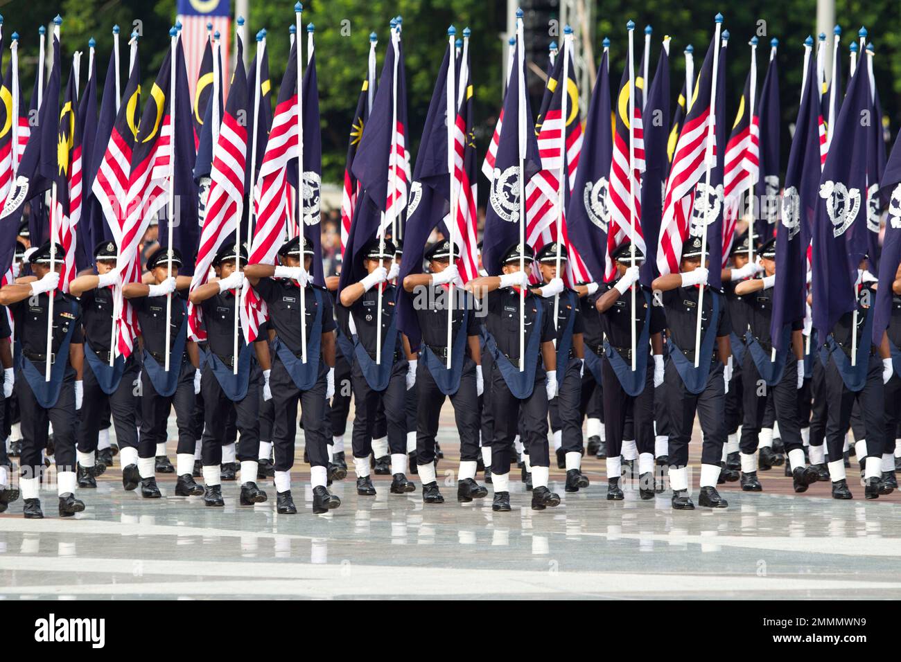 The Royal Malaysia Police with national flags march during the 61st ...
