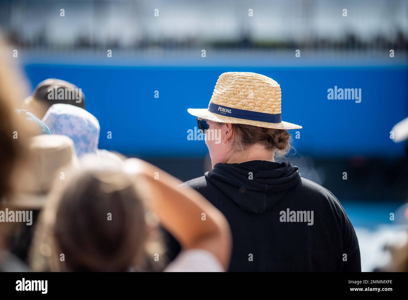 tennis fan watching a tennis match at the australian open eating food ...