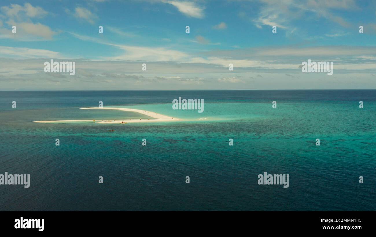 Tropical white island and sandy beach with tourists surrounded by coral ...