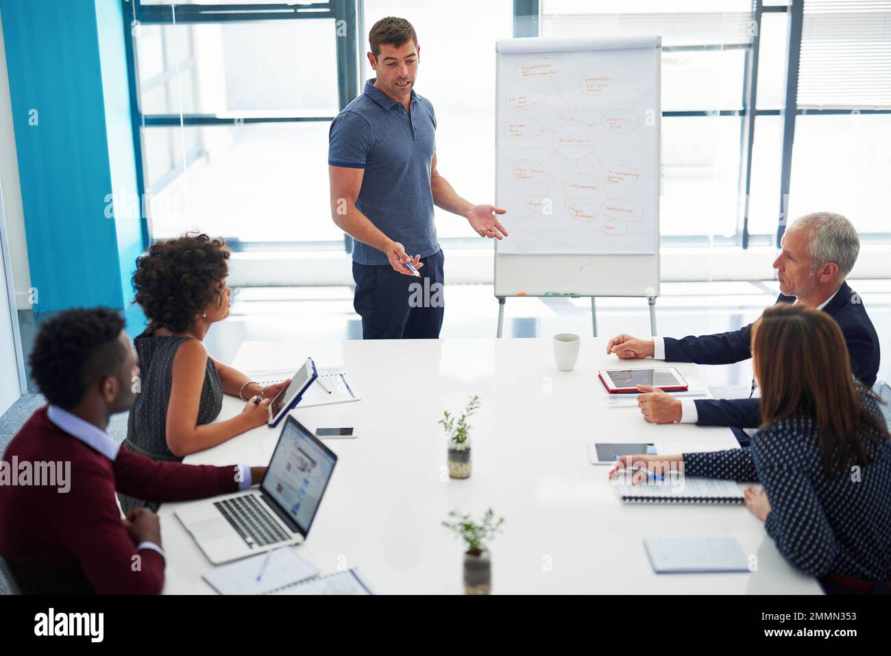 Defining the steps to corporate success. a young businessman giving a ...