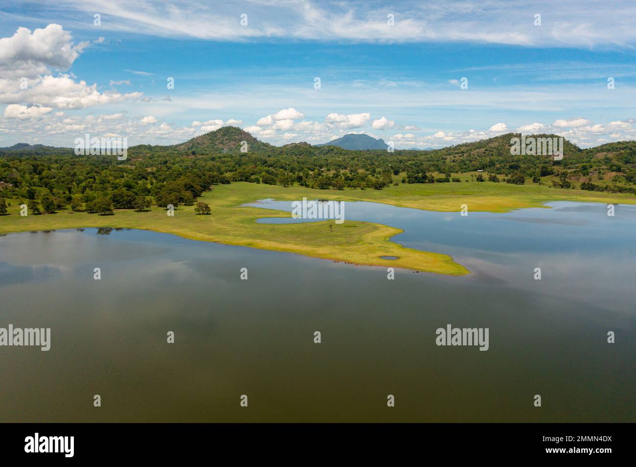 Top view of valley with a lake and tropical vegetation against a blue ...