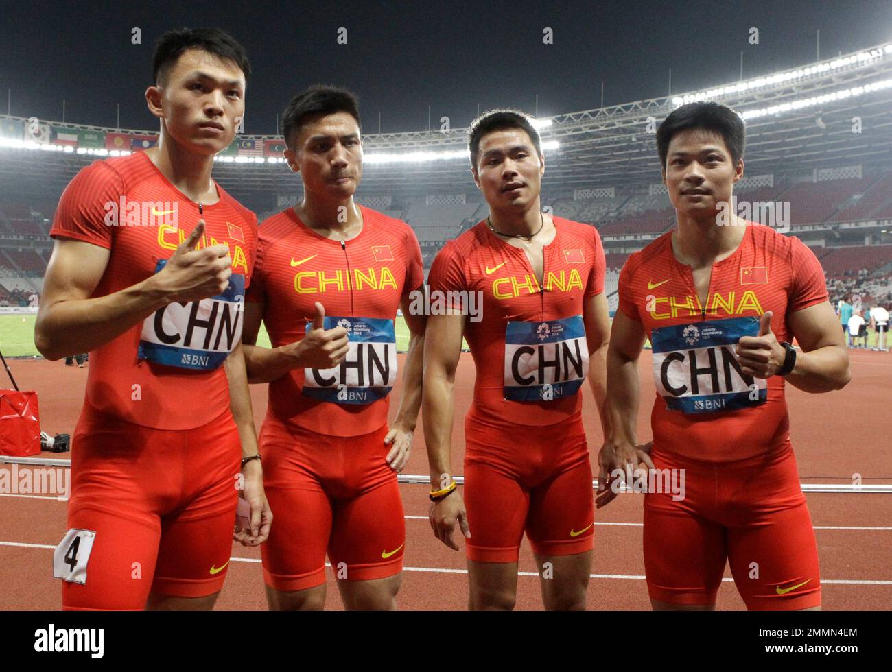 China's men's 4x100m relay team pose for a photo after their third ...