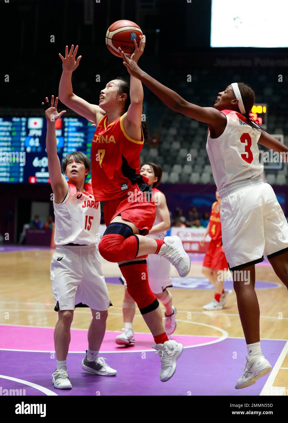 China's Ting Shao, center, drives past Japan's Shiori Yasuma,left, and ...