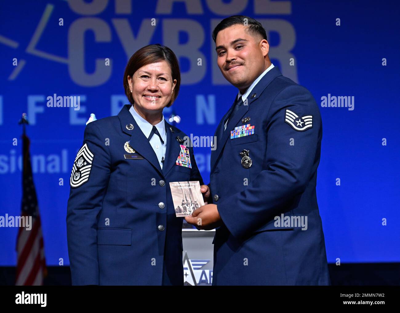 Chief Master Sgt. of the Air Force JoAnne S. Bass poses with an airman ...