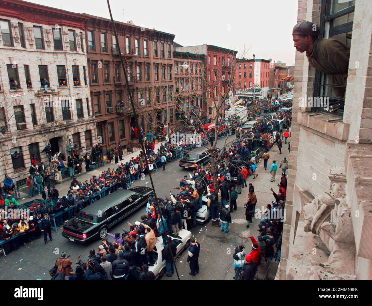 FILE - In this March 18, 1997 file photo, a man looks out his apartment ...