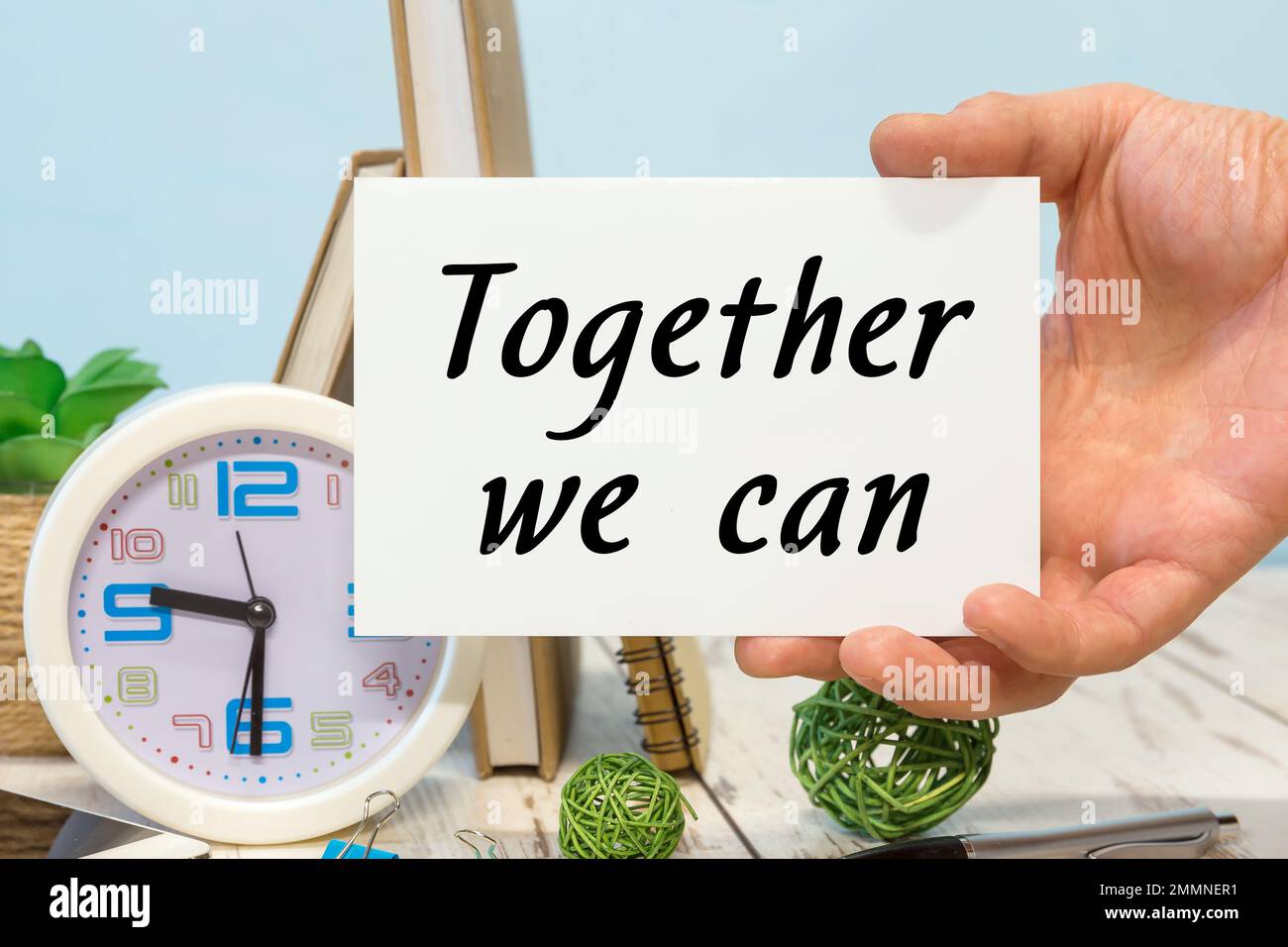 Together We Can - text on a card in your hand next to office supplies ...