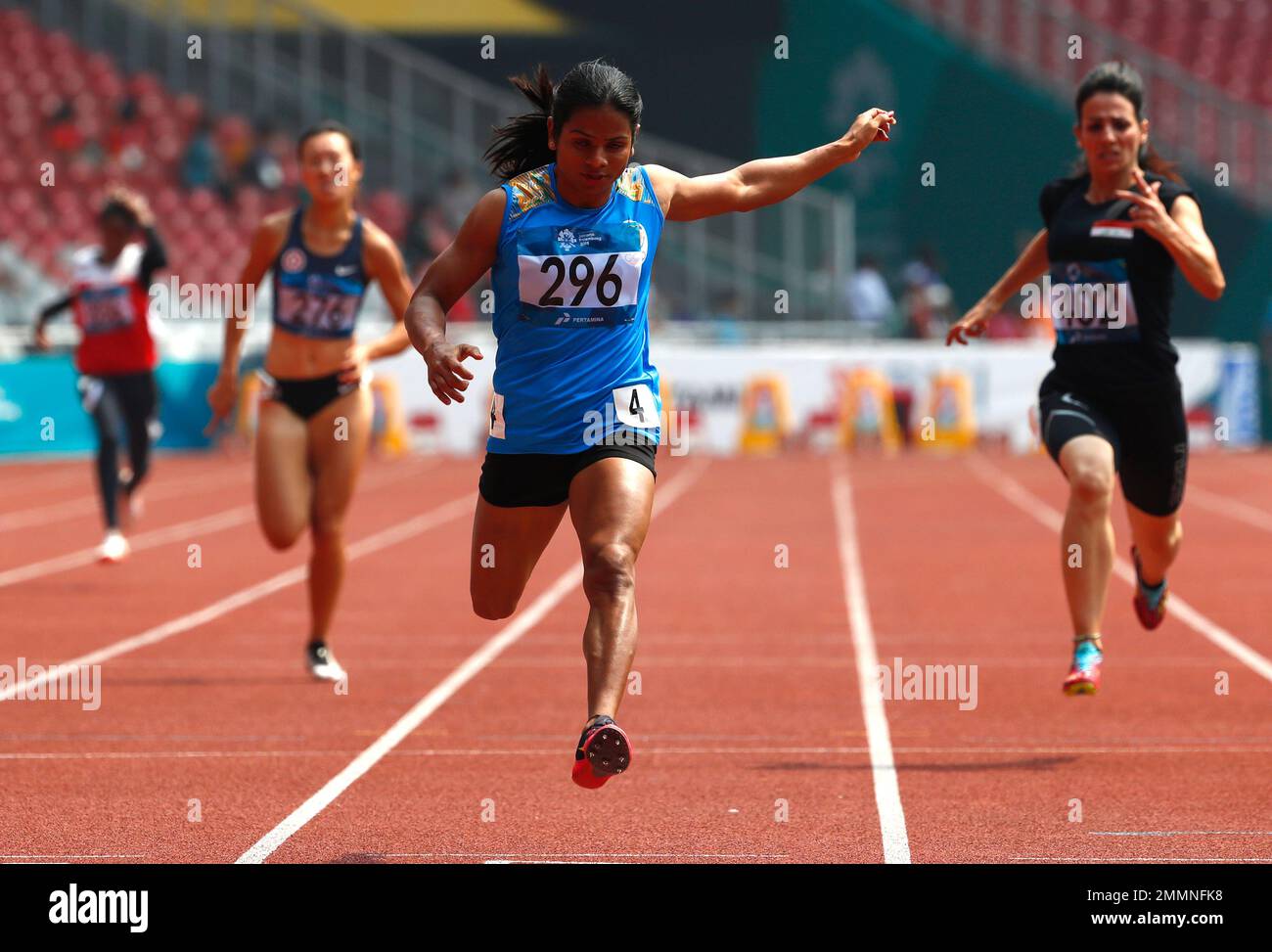 India's Dutee Chand crosses the finish line in her heat of the women's 200m during the athletics ...