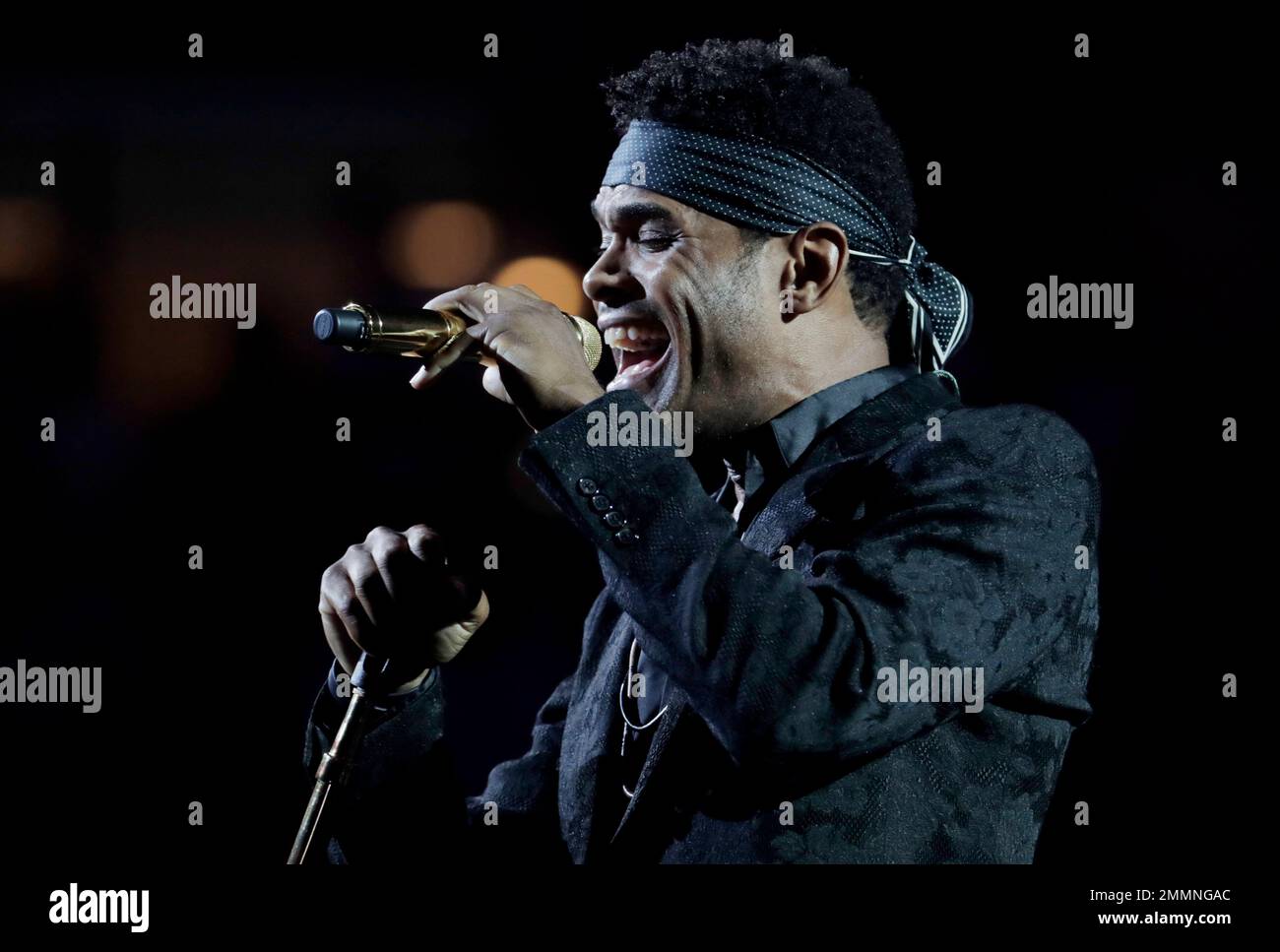 Singer Maxwell performs the national anthem before the opening night ...