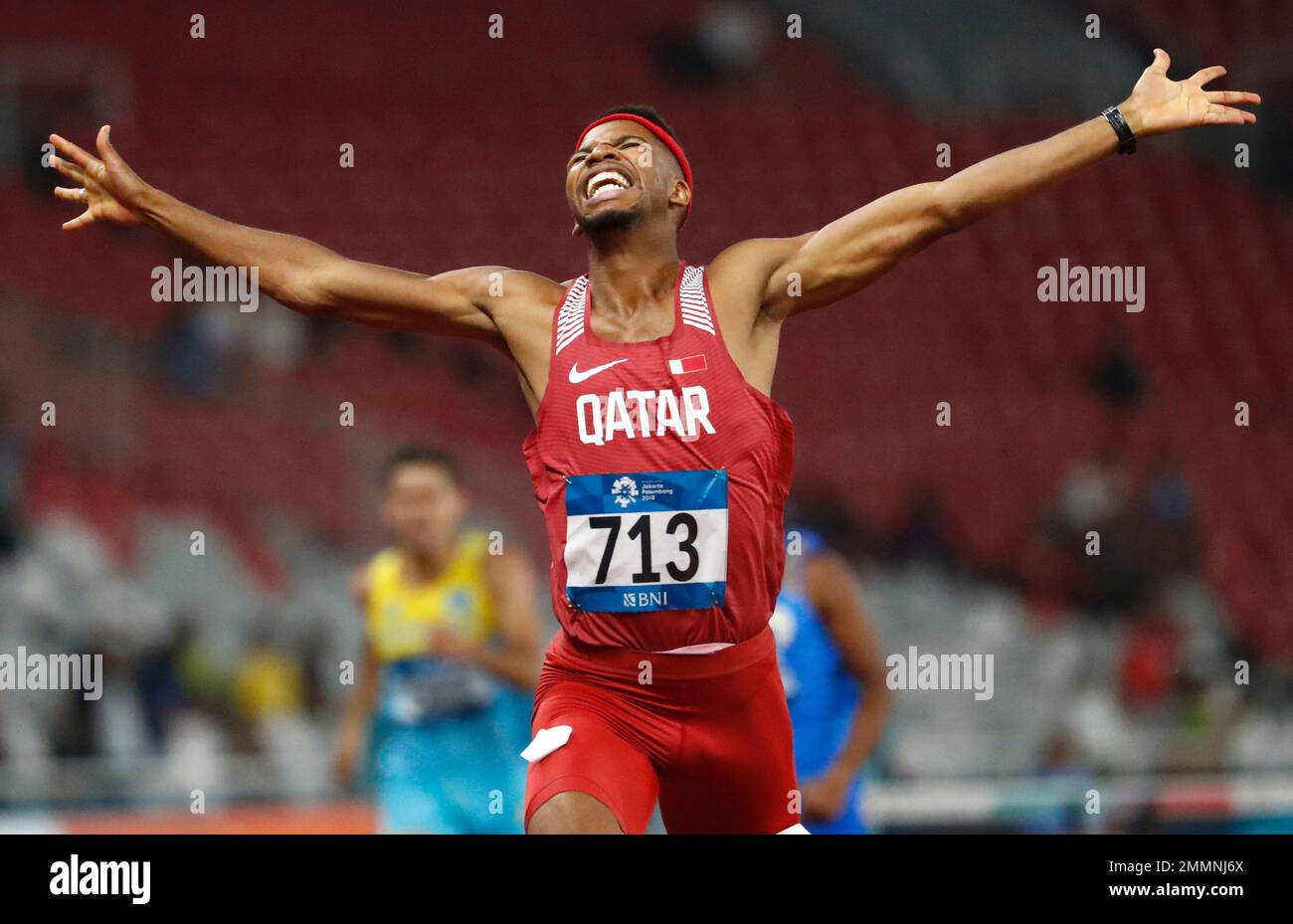 Qatar's Abderrahman Samba celebrates as he crosses the finish line to ...