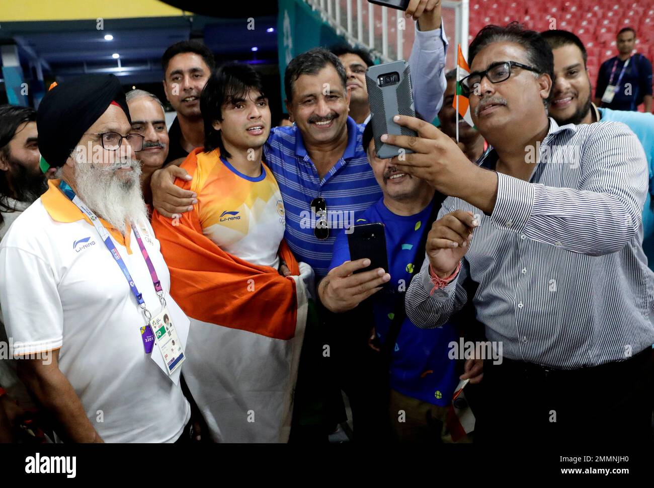 India's Neeraj Chopra is surrounded by fans as he celebrates his win in ...