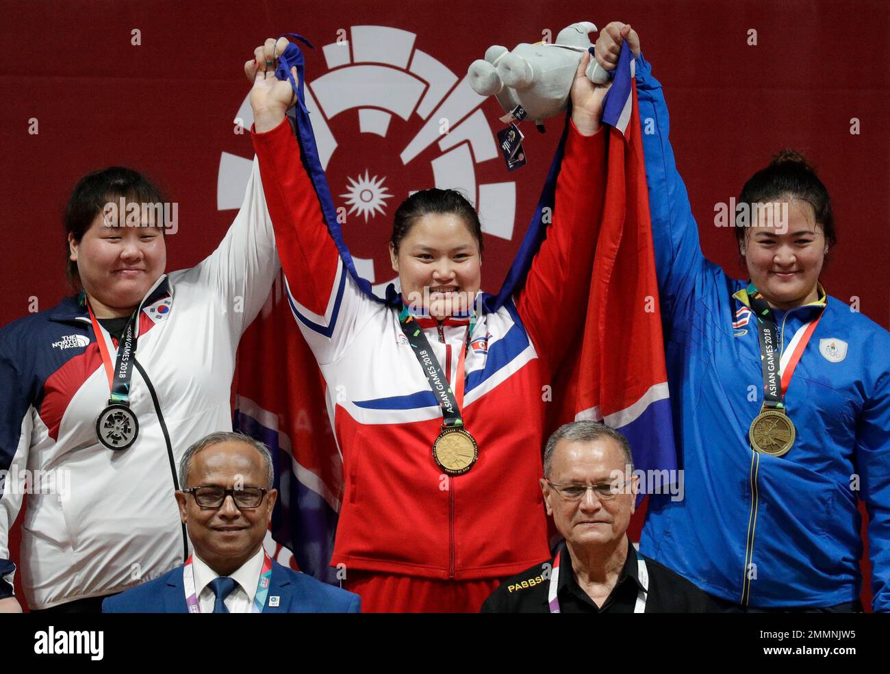 Gold medalist North Korea's Kim Kuk Hyang, center, raises hands with ...