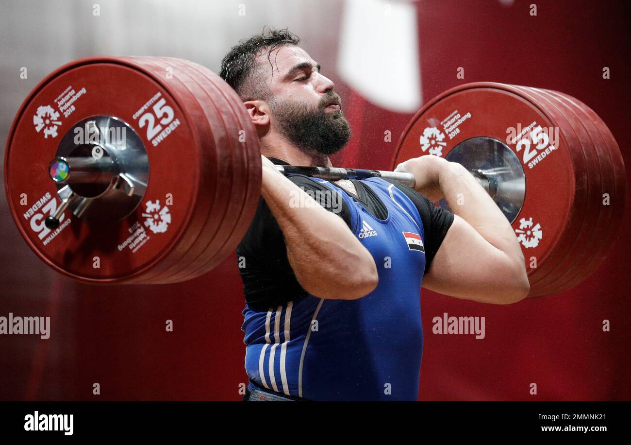 Syria's Man Assad compete at the men's +105kg weightlifting at the 18th ...