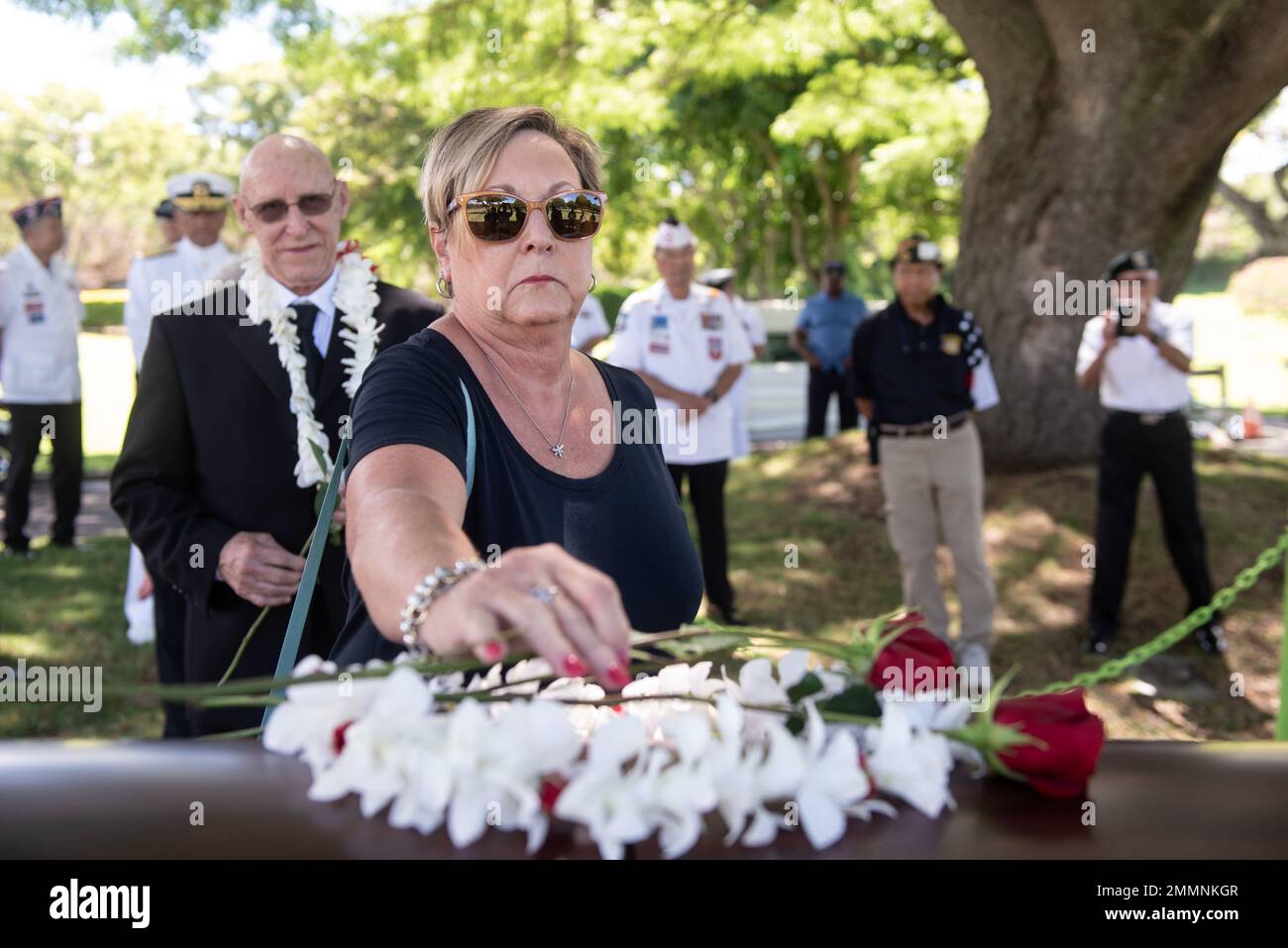 Kim Sutton, niece of Petty Officer 1st Class Beoin Corzatt, places a ...