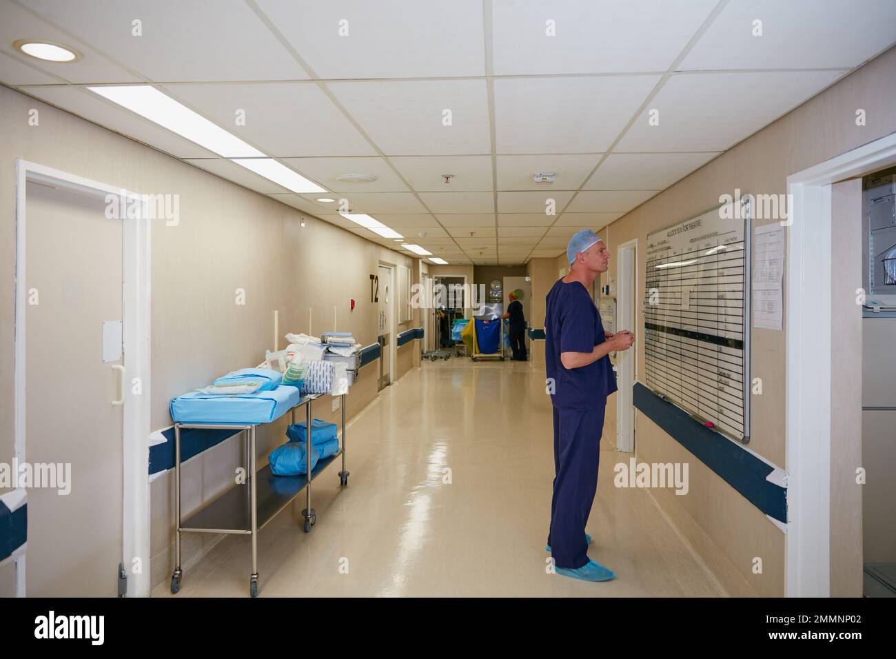Checking in for his shift. Full length shot of a male doctor writing on ...