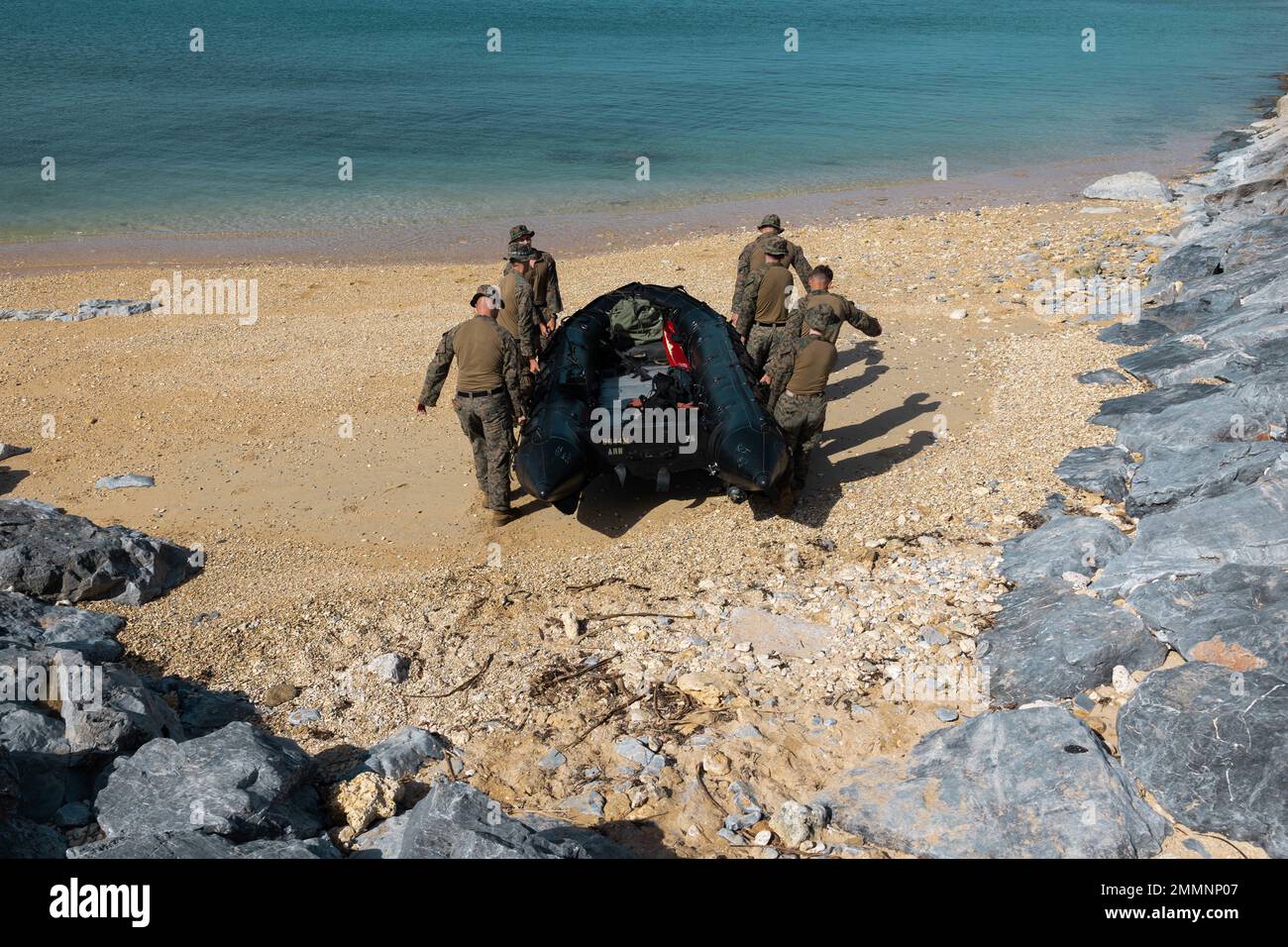 U.S. Marines with 1st Battalion, 2nd Marine Regiment, carry a combat ...