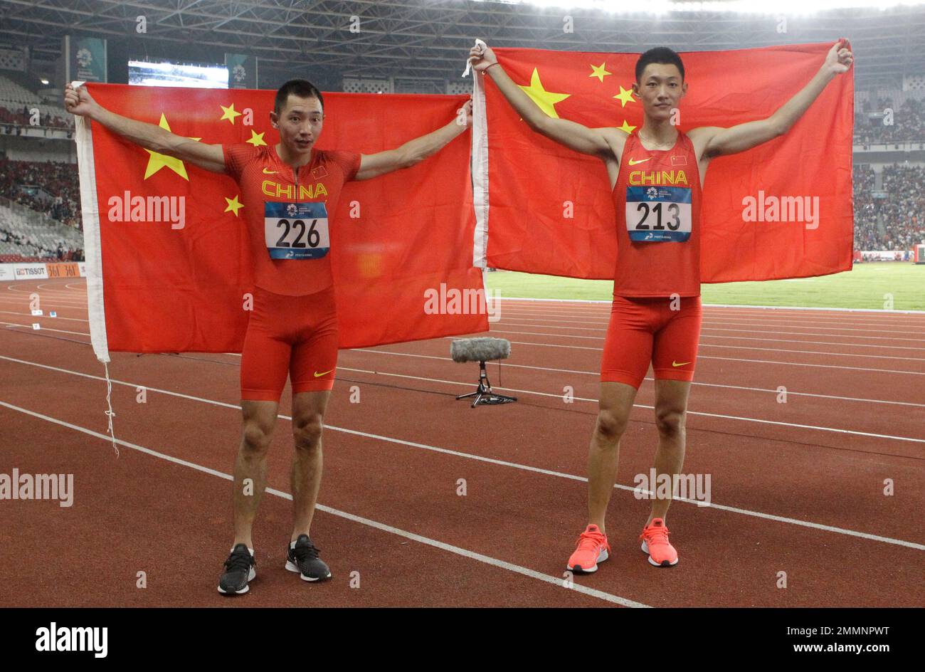Men's long jump winner China's Wang Jianan, left, stands with second ...