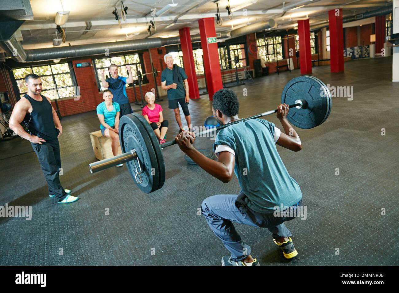 When nothing goes right go lift. a man lifting weights while a group of ...