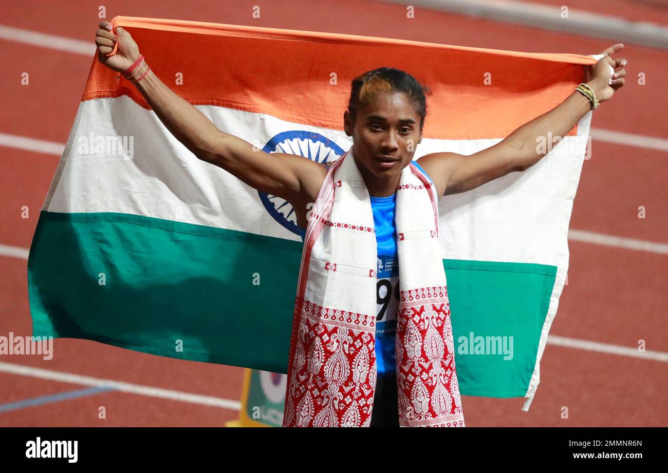 India's Hima Das celebrates after her second place finish in the women ...