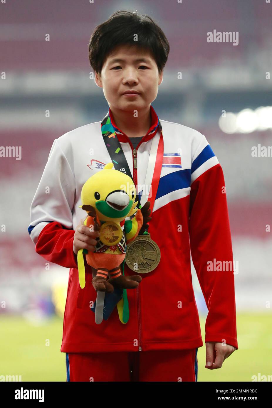 North Korea's Kim Hye Song stands on the podium after receiving her ...