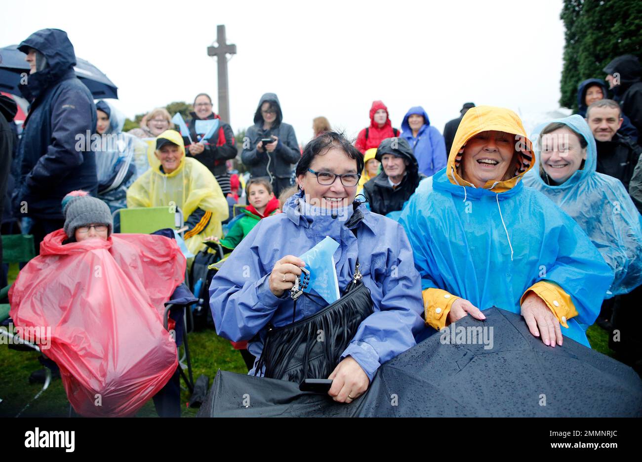 People wait for the arrival of Pope Francis in front of the Knock ...