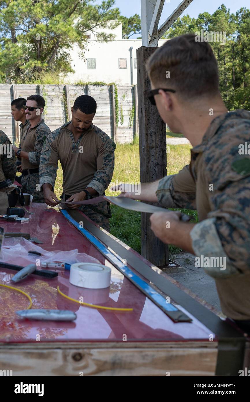 U.S. Marine Corps Sgt. Christian Miller (middle), an assistant team ...