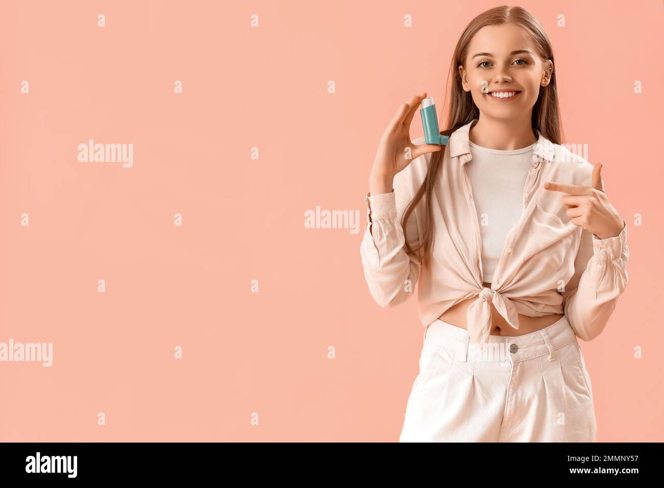 Young woman with inhaler on pink background Stock Photo - Alamy