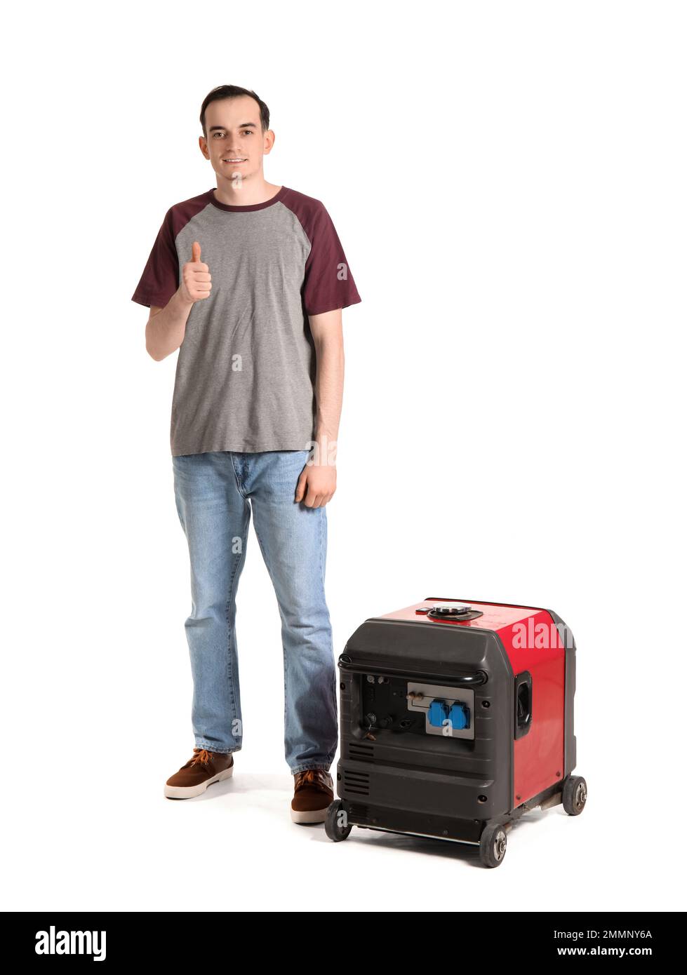 Young man with portable gasoline generator showing thumb-up on white ...