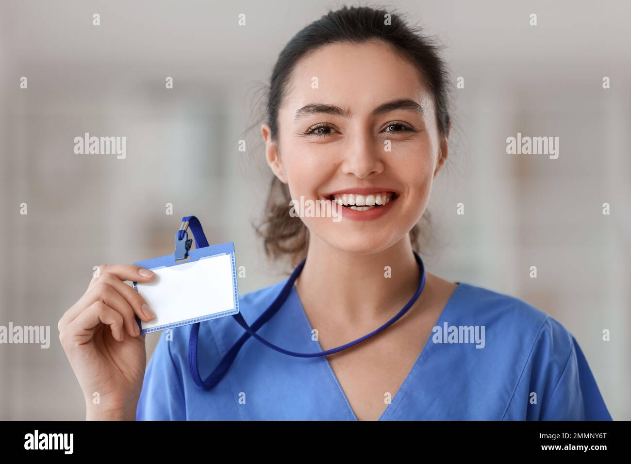 Female medical assistant with badge in clinic Stock Photo - Alamy