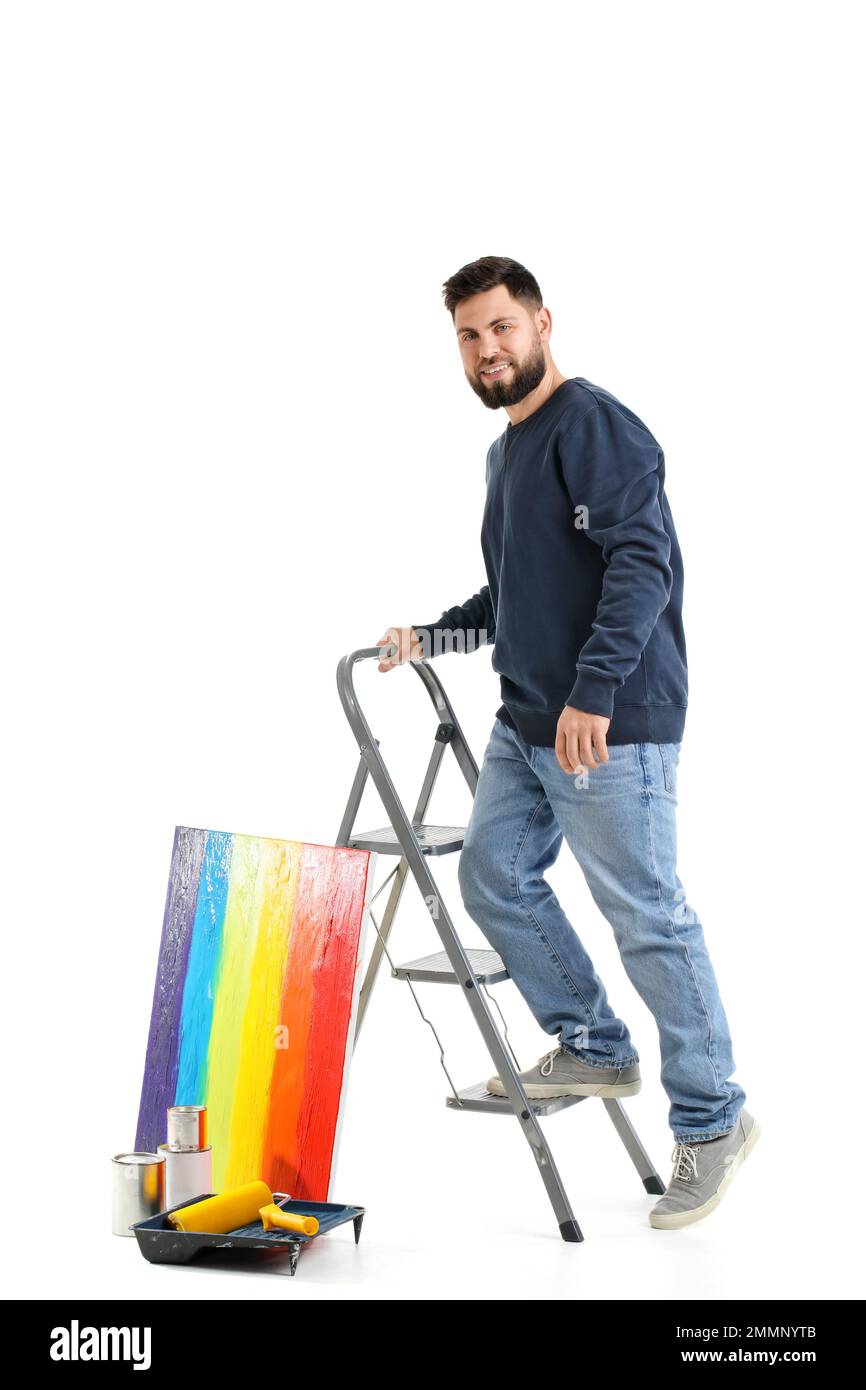 Young man with ladder and painting on white background Stock Photo - Alamy