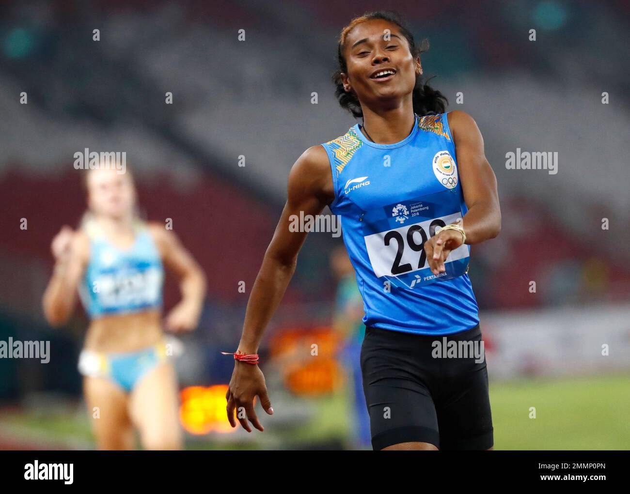 India's Hima Das reacts as she crosses the finish line in her women's 400m heat during the ...