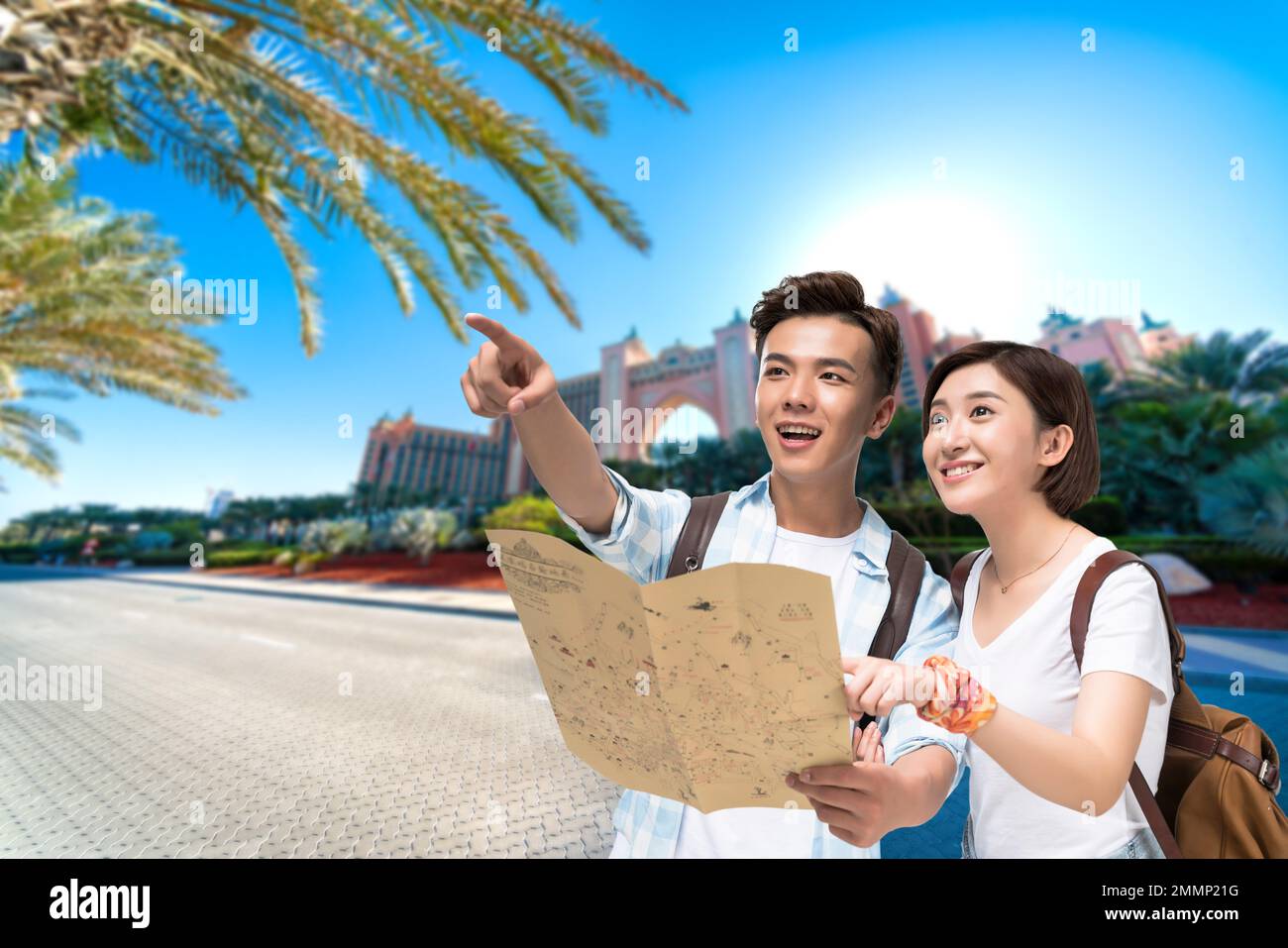 Happy young couple holding a map Stock Photo - Alamy