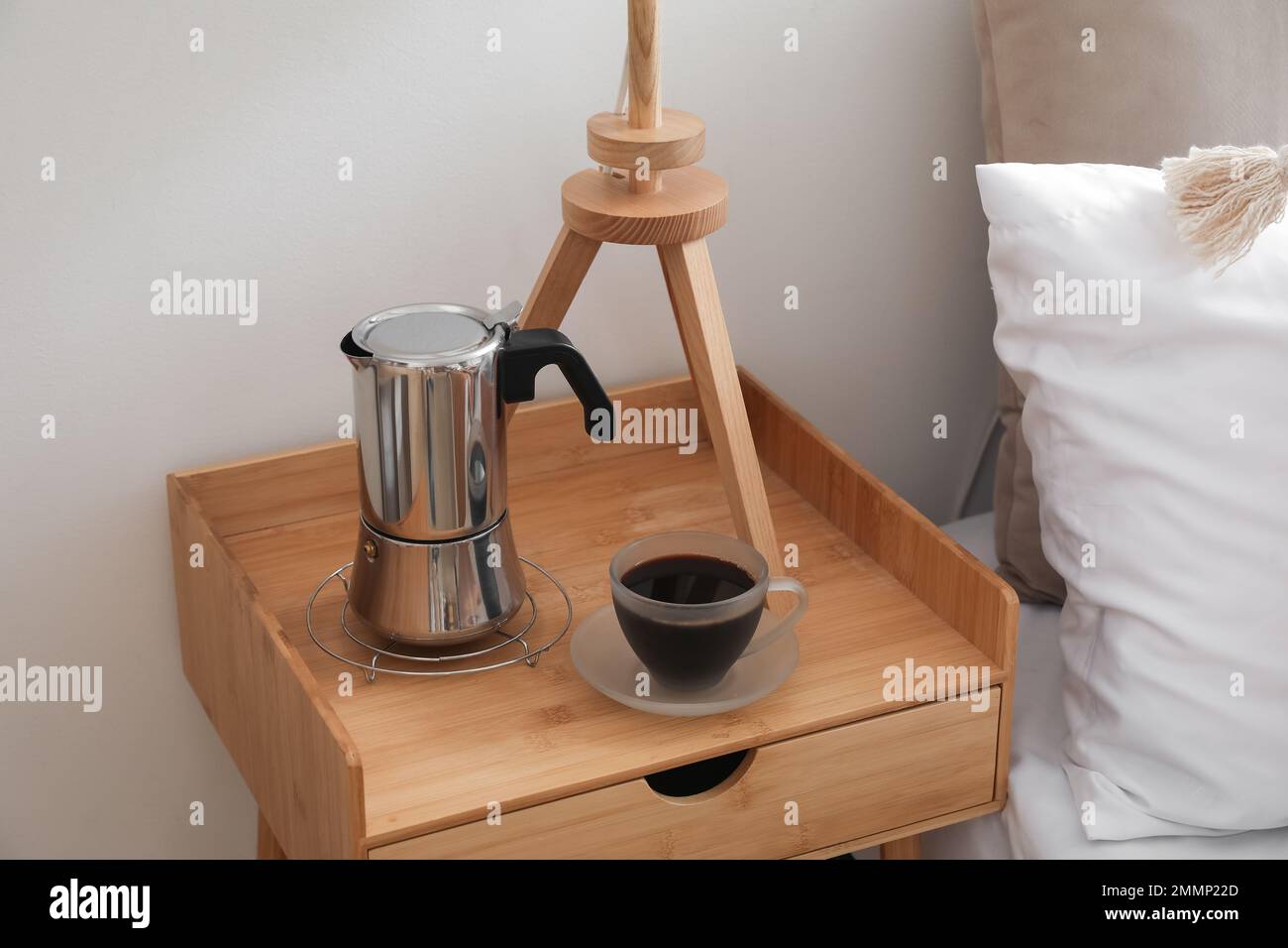 Geyser coffee maker and cup of espresso on nightstand near bed Stock ...