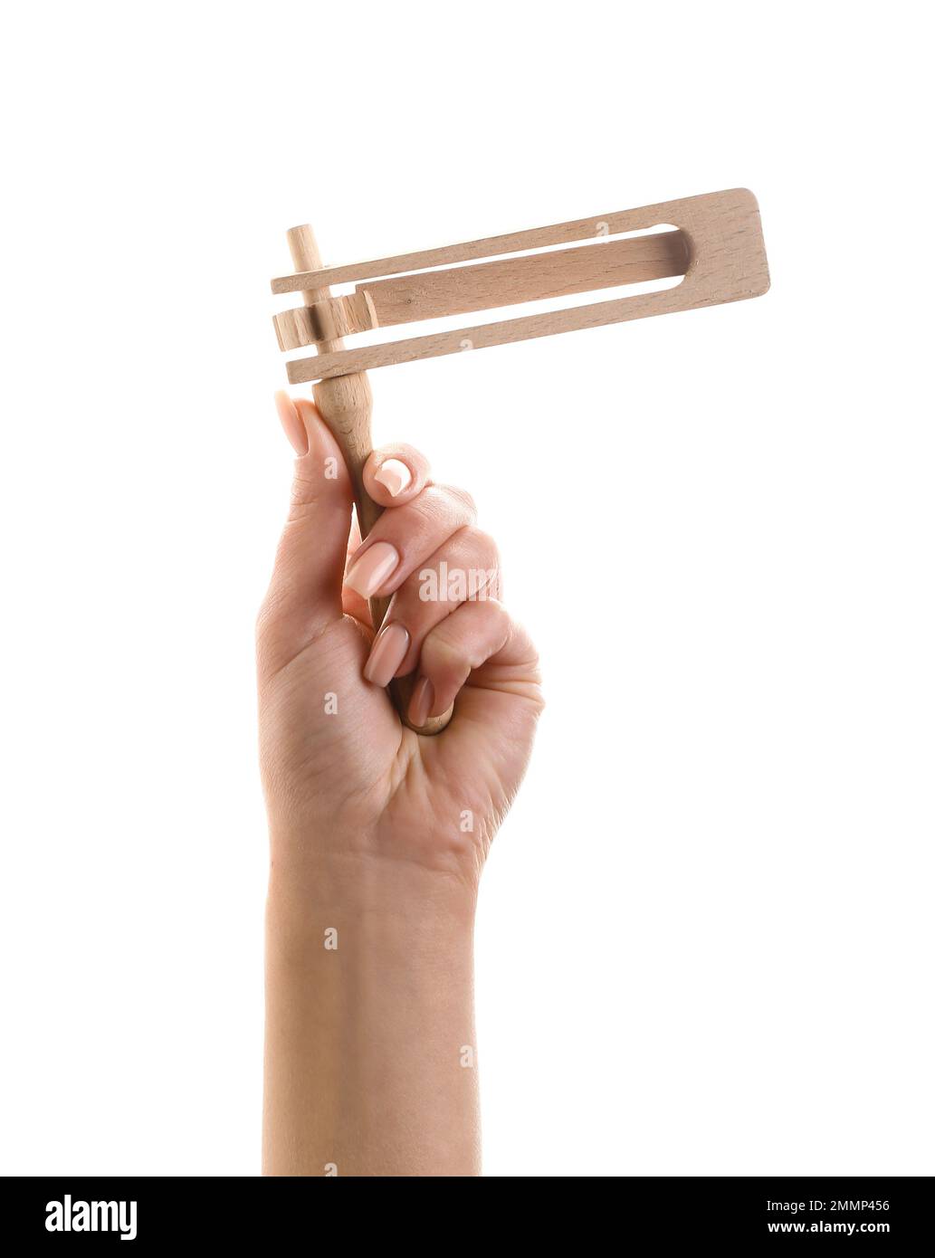 Woman with wooden Jewish rattle for Purim holiday on white background ...