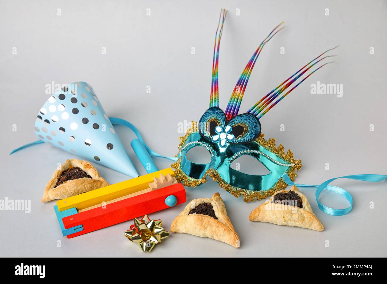Hamantaschen cookies, carnival mask, party hat and rattle for Purim ...
