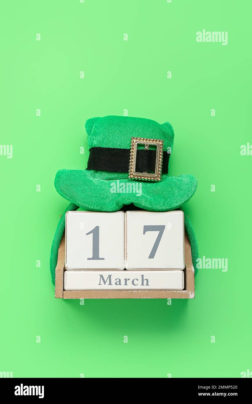 Leprechaun hat and calendar with date of St. Patrick's Day on green ...